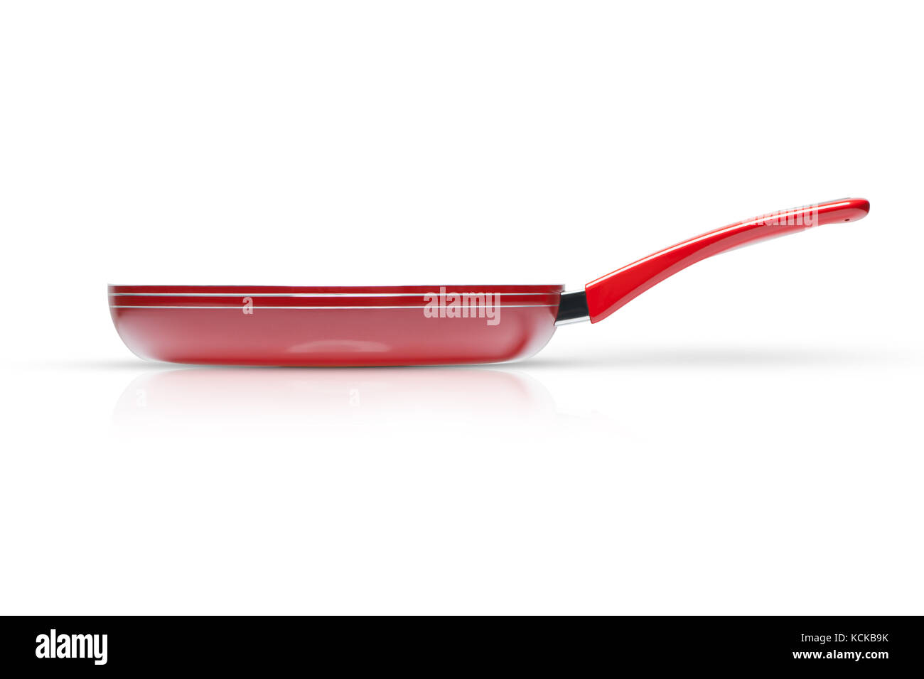 one frying pan of red color on a white background closeup Stock Photo ...