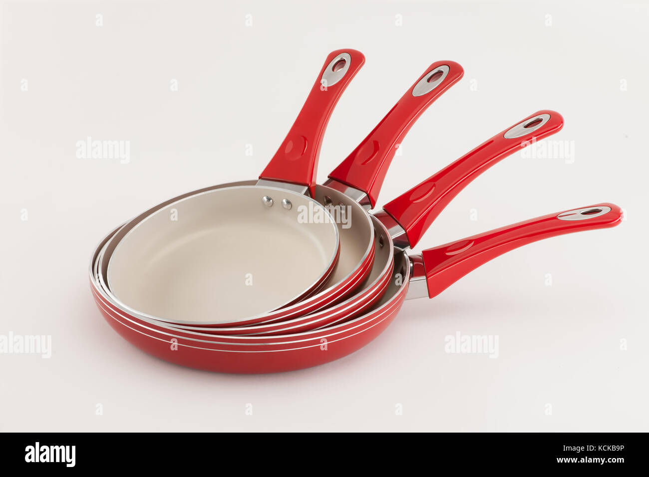 Set frying pans of red color on a white background closeup Stock Photo ...