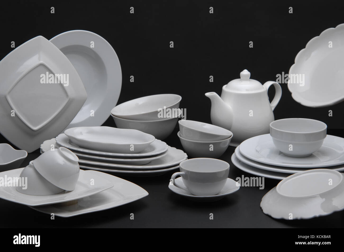 large set of white kitchen ware on a black background closeup Stock ...
