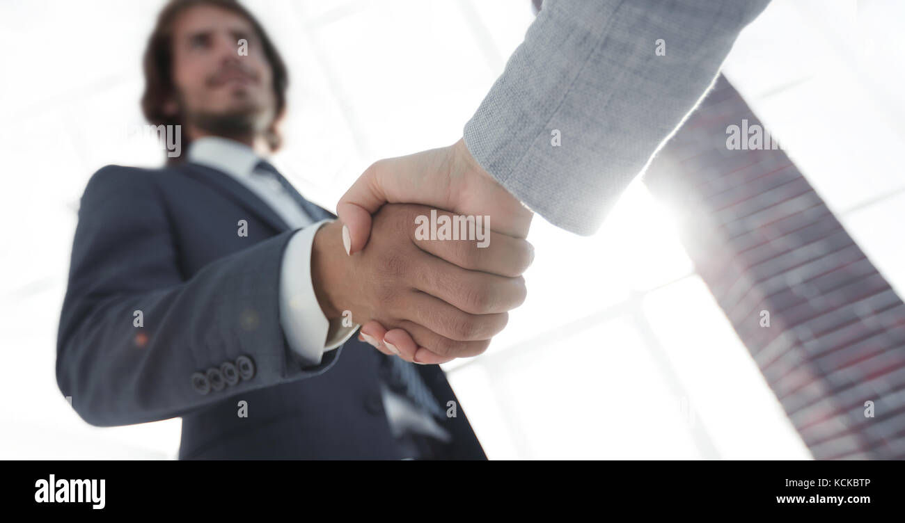 Excited smiling businessman handshaking partner at meeting Stock Photo ...