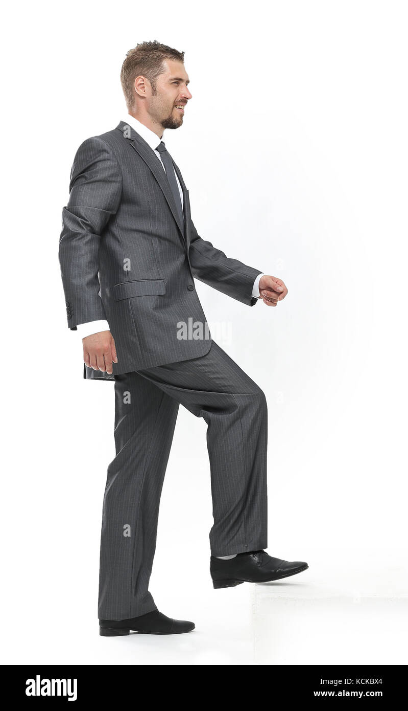 in full growth.side view.businessman stepping forward Stock Photo - Alamy