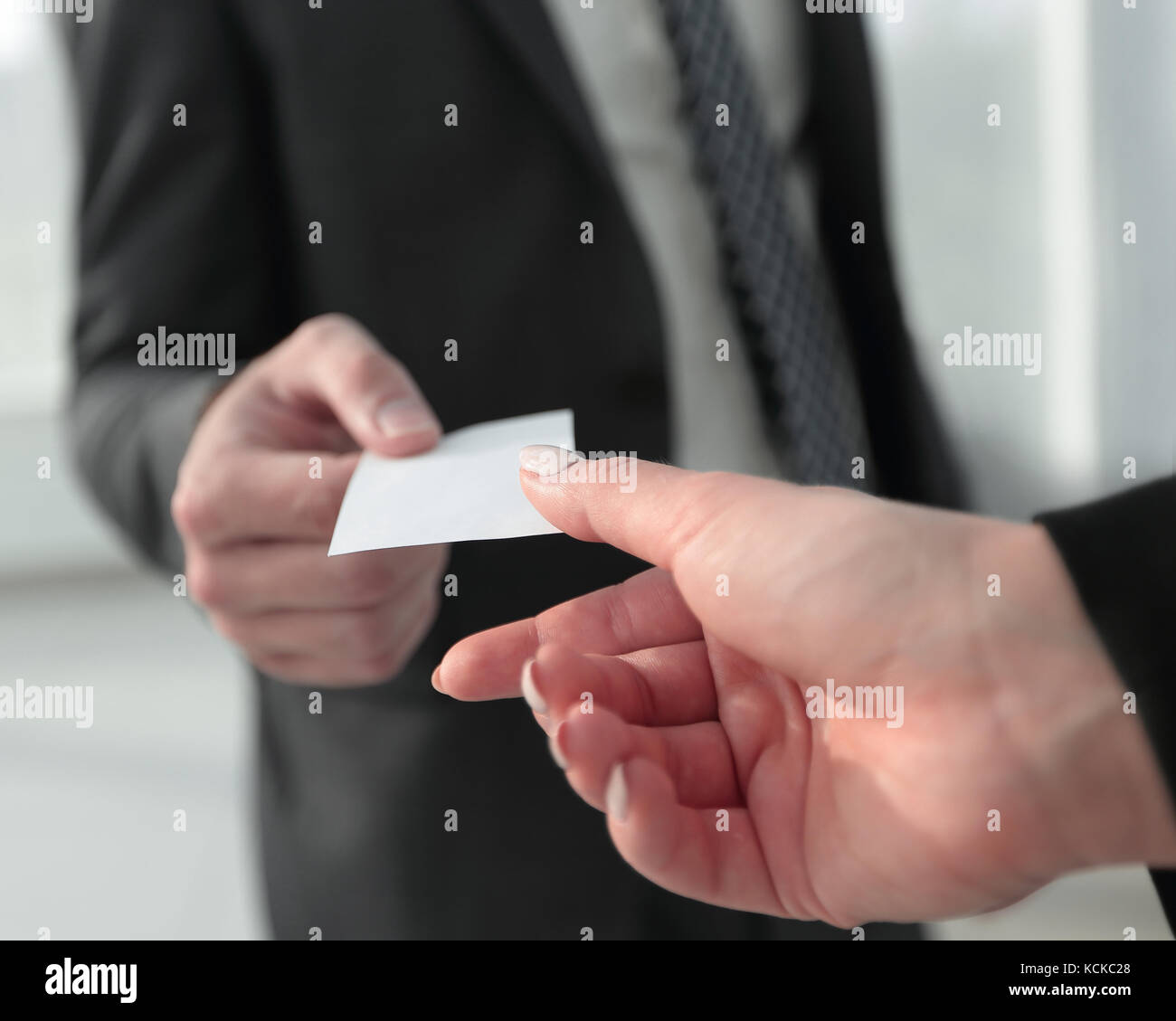 Close-up of two businesspeople exchanging visiting card Stock Photo - Alamy