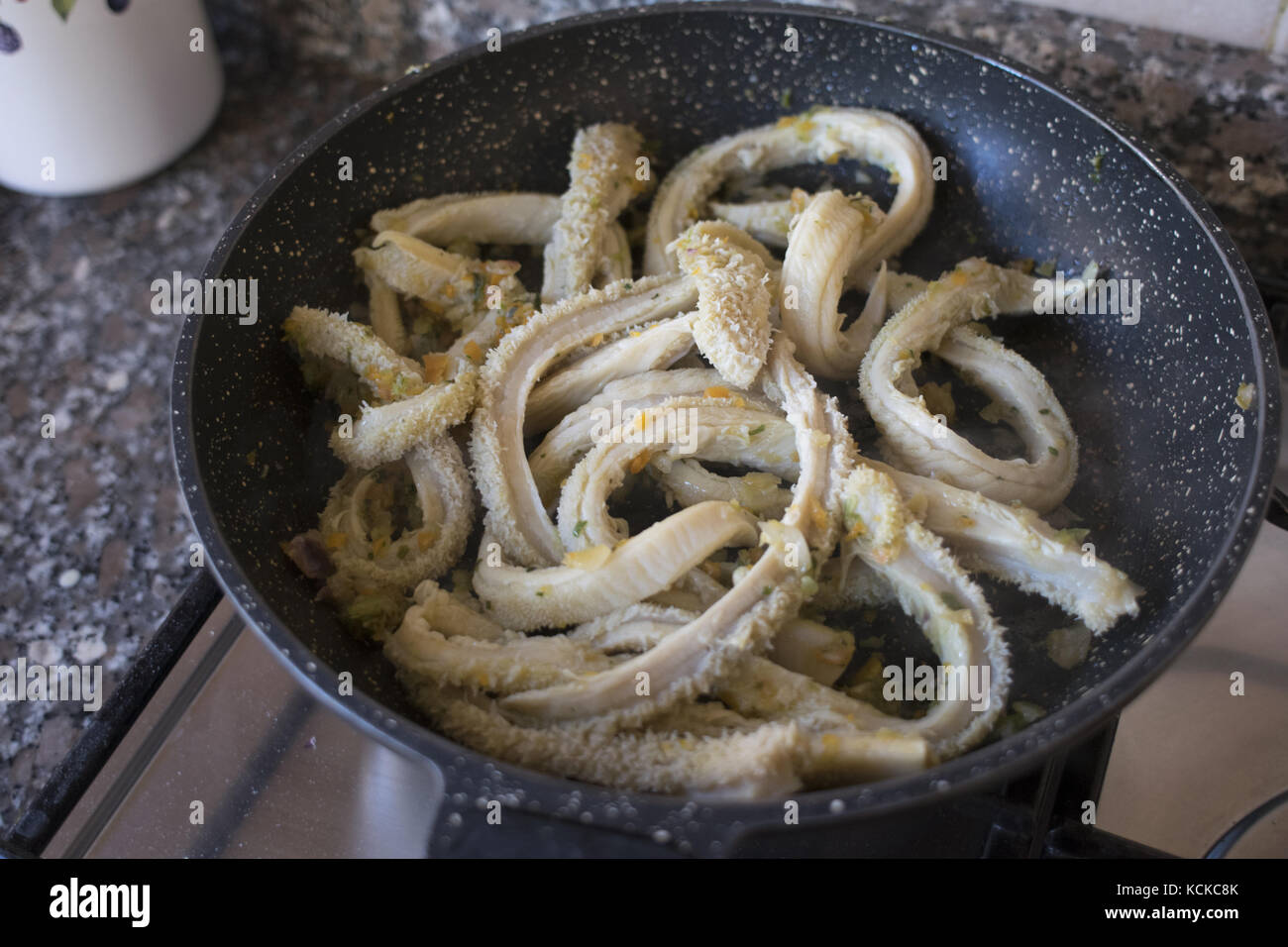 cooking tripe in pan with onion and chopped vegetables Stock Photo - Alamy