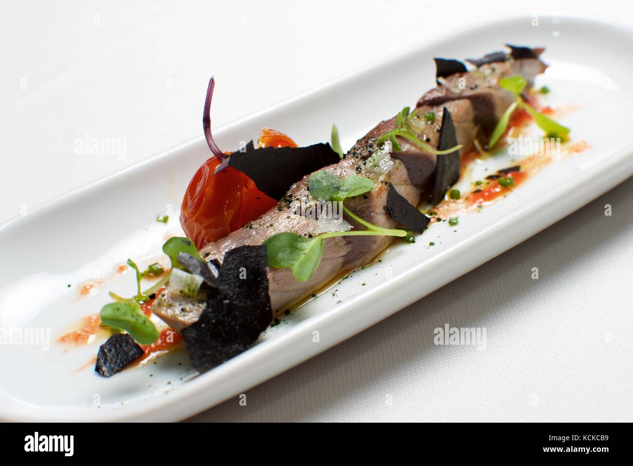 Typical tuna tapa in a small white dish Stock Photo - Alamy