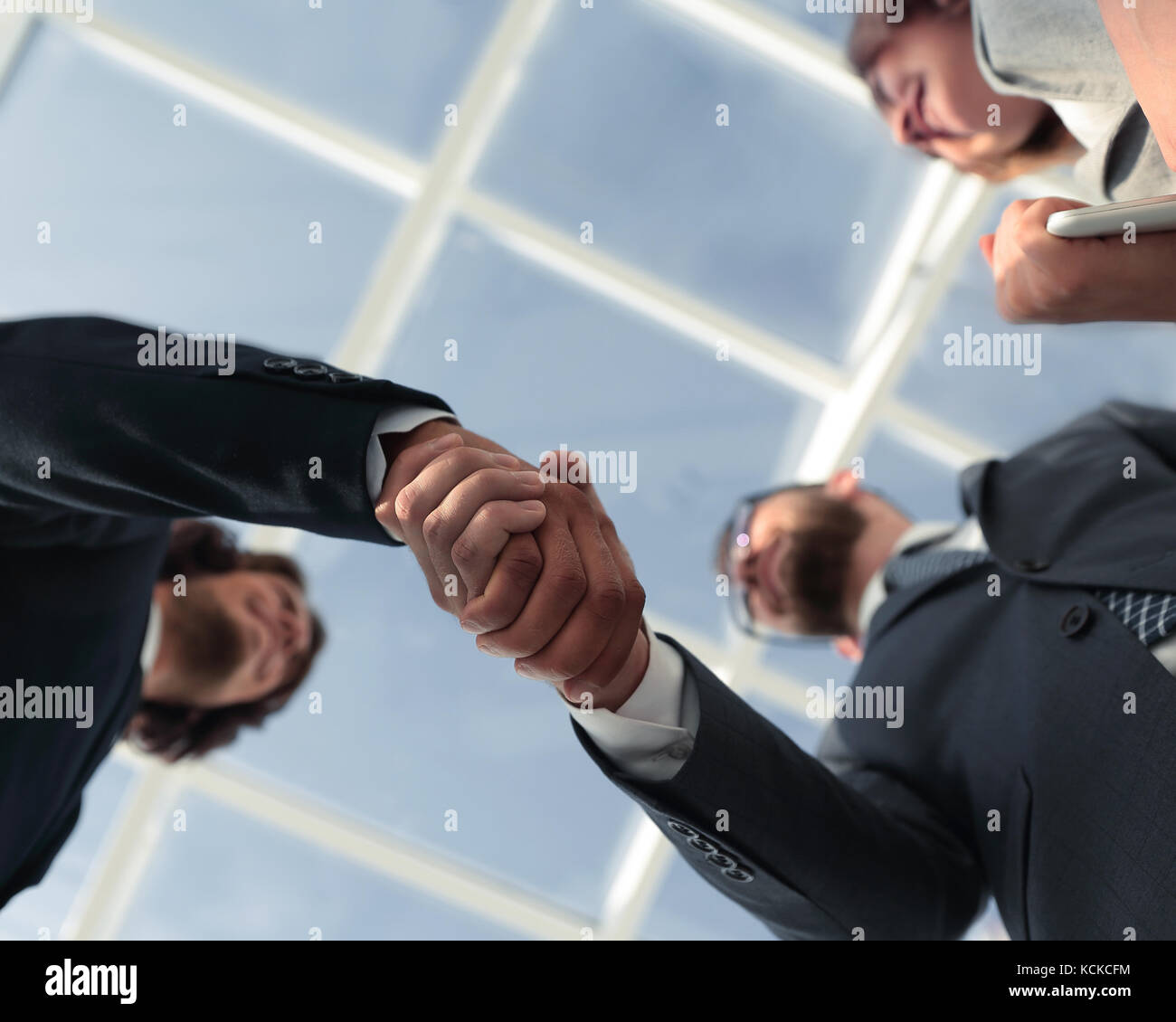 Close-up shot of businessmen shaking hands in the office Stock Photo ...
