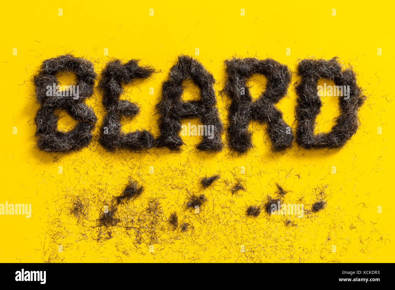 Beard sign made in beard trimming angled on a bright yellow background ...