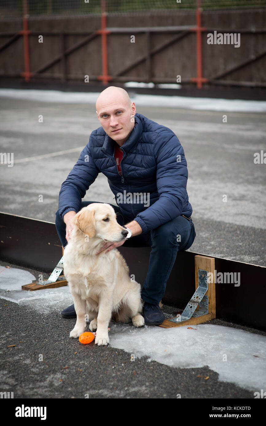 Golden Retriever dog and man Stock Photo - Alamy