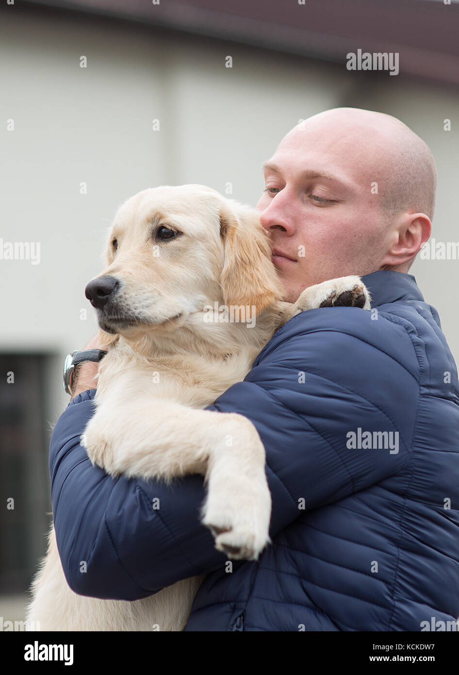 Golden Retriever dog and man Stock Photo - Alamy