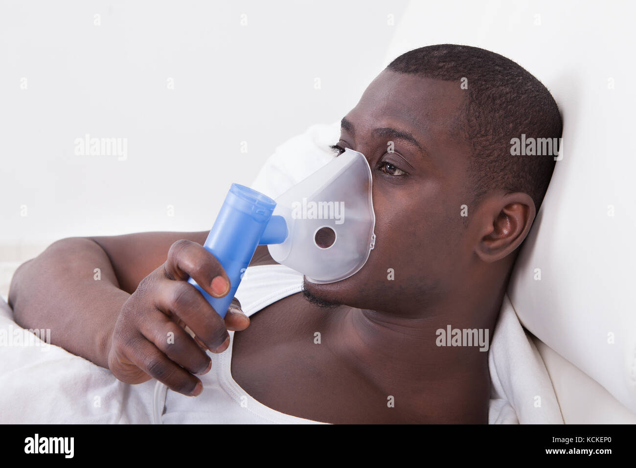 Young Man Doing Inhalation Through Oxygen Mask Stock Photo - Alamy