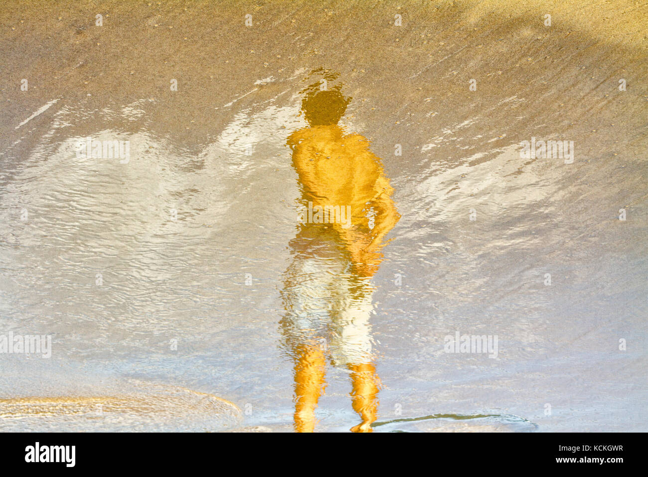 Reflex on the water of a standing man at Acores Beach. Florianopolis ...