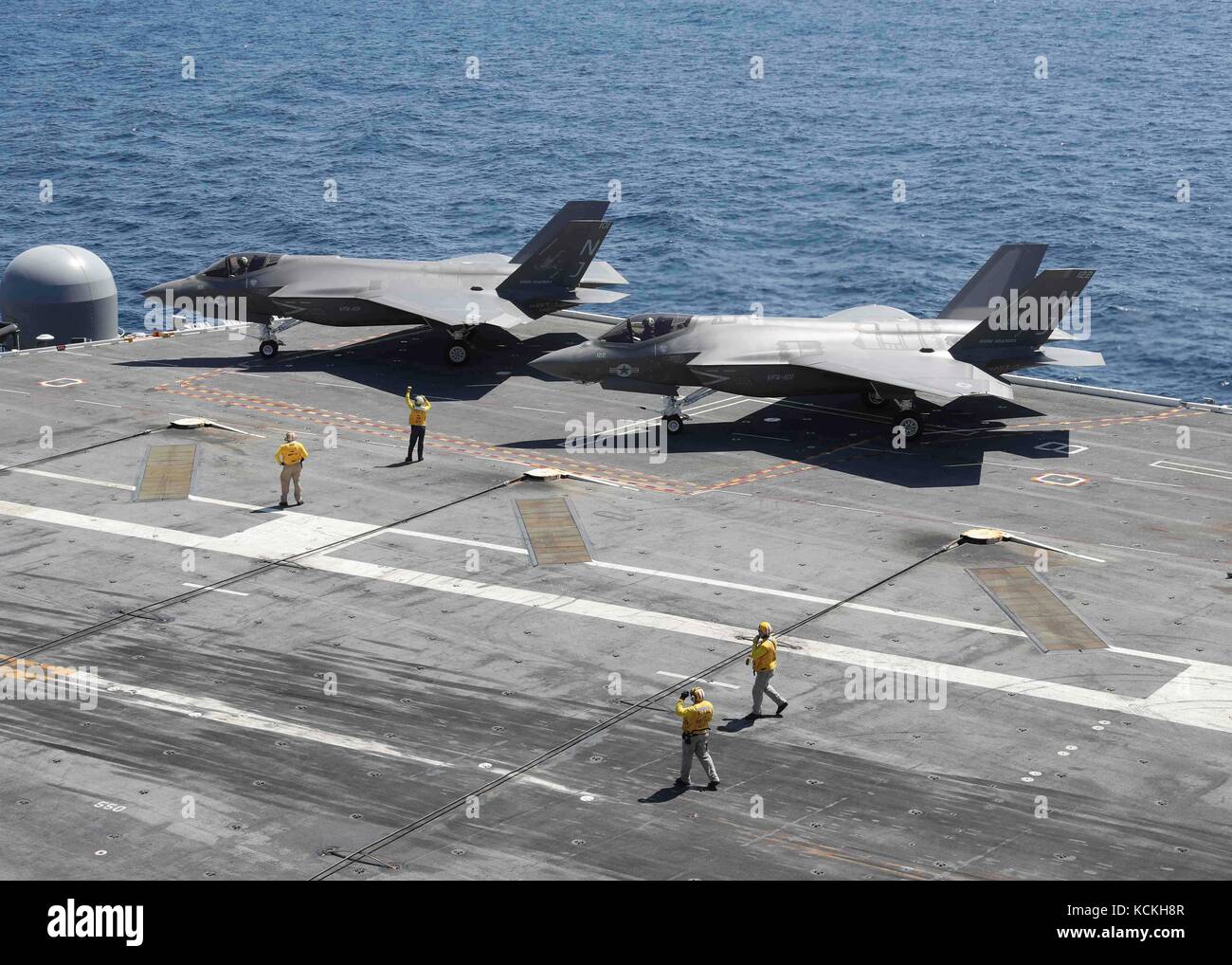 Two U.S. Navy F-35C Lightning II stealth fighter jet aircraft sit on the flight deck of the U.S ...