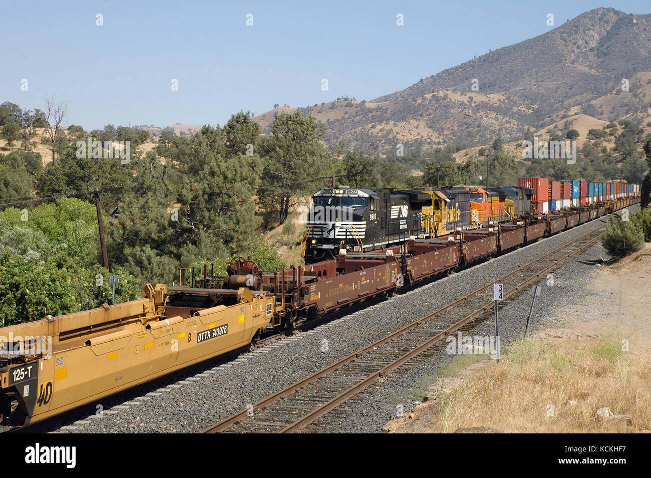 Freight train descending from Teachapi Loop passes an empty container ...