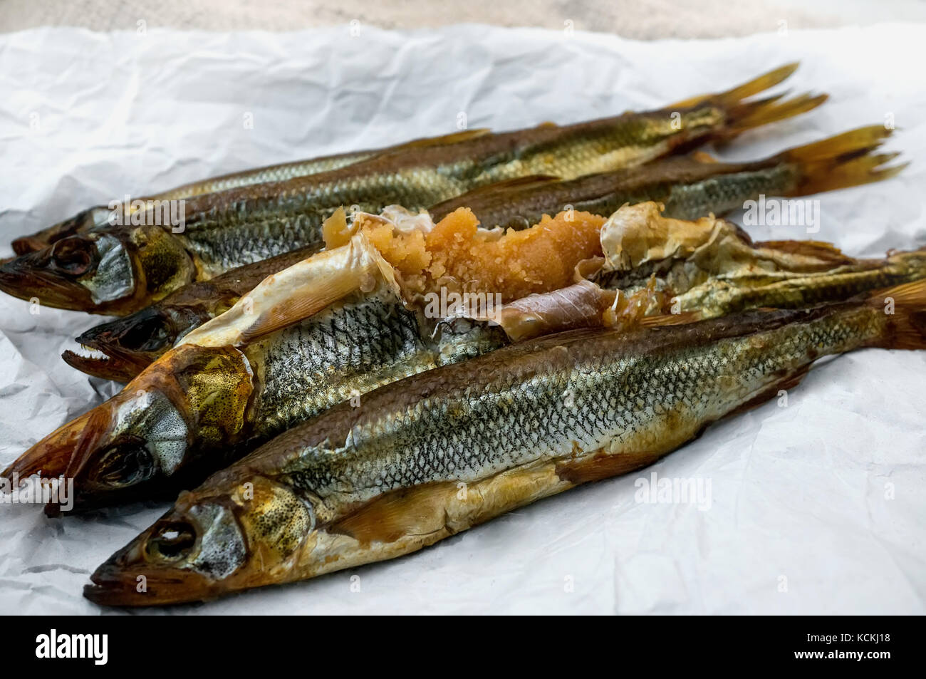 Delicious smoked fish smelt osmerus caviar lying on light-colored paper ...