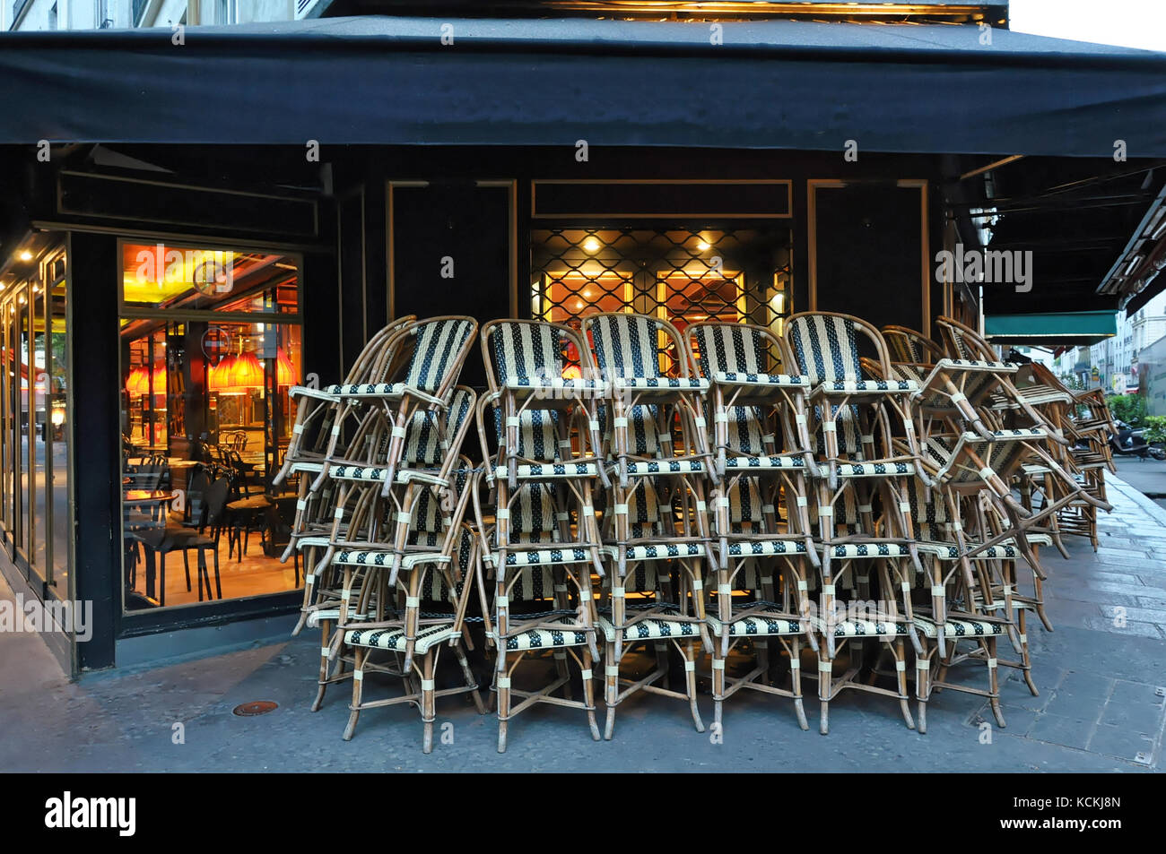 Parisian cafe chairs in early morning Stock Photo - Alamy