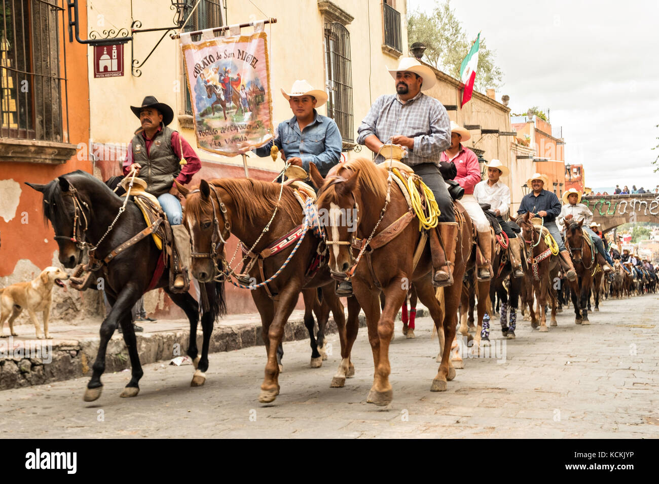 A procession of Mexican cowboys ride through the streets on the final ...