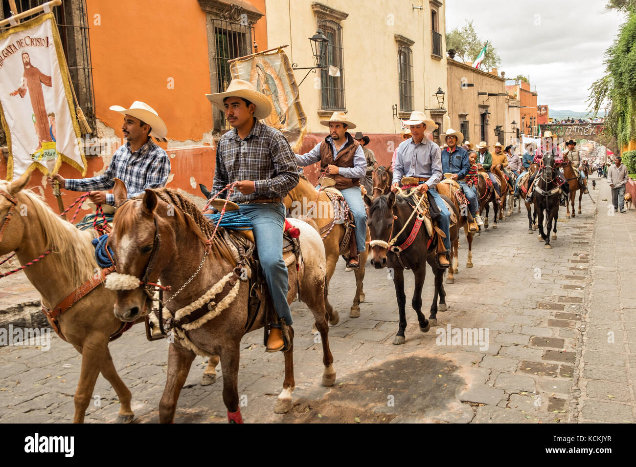 A procession of Mexican cowboys ride through the streets on the final ...