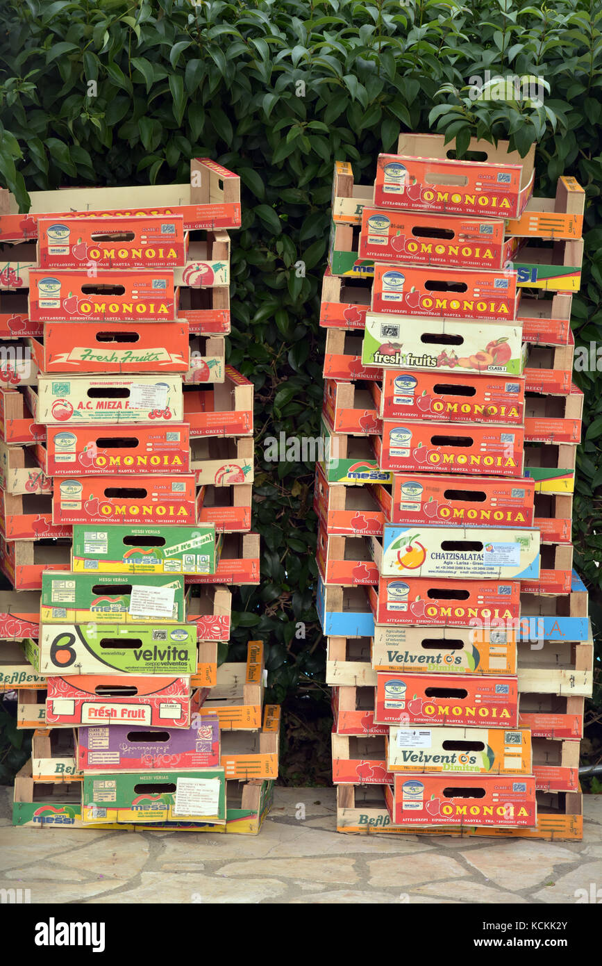 Two piles of brightly coloured wooden packing crates outside of a ...