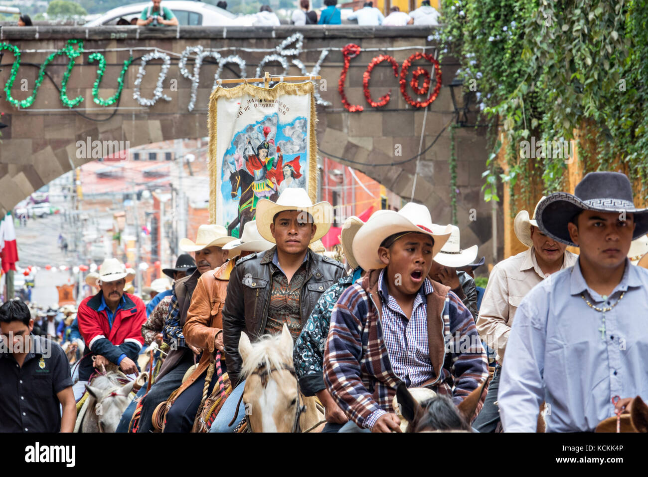A procession of Mexican cowboys ride through the streets on the final ...