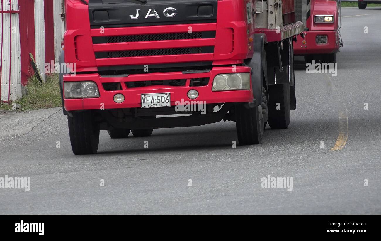 Red Truck Driving On Road Stock Photo - Alamy