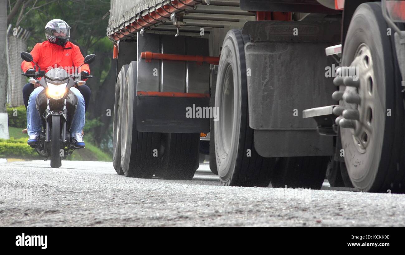 Motorcycle Driving With Truck Stock Photo - Alamy