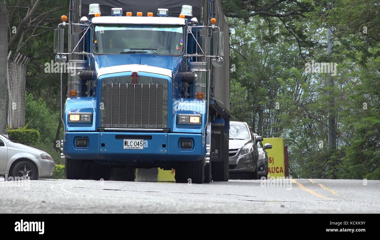 Blue Tractor Trailer Driving On Road Stock Photo - Alamy