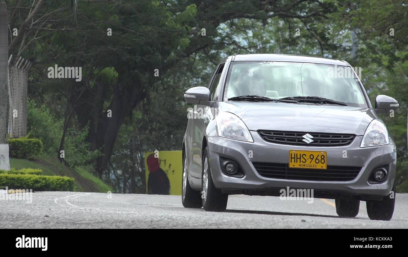 Small Car Driving On Road Stock Photo - Alamy