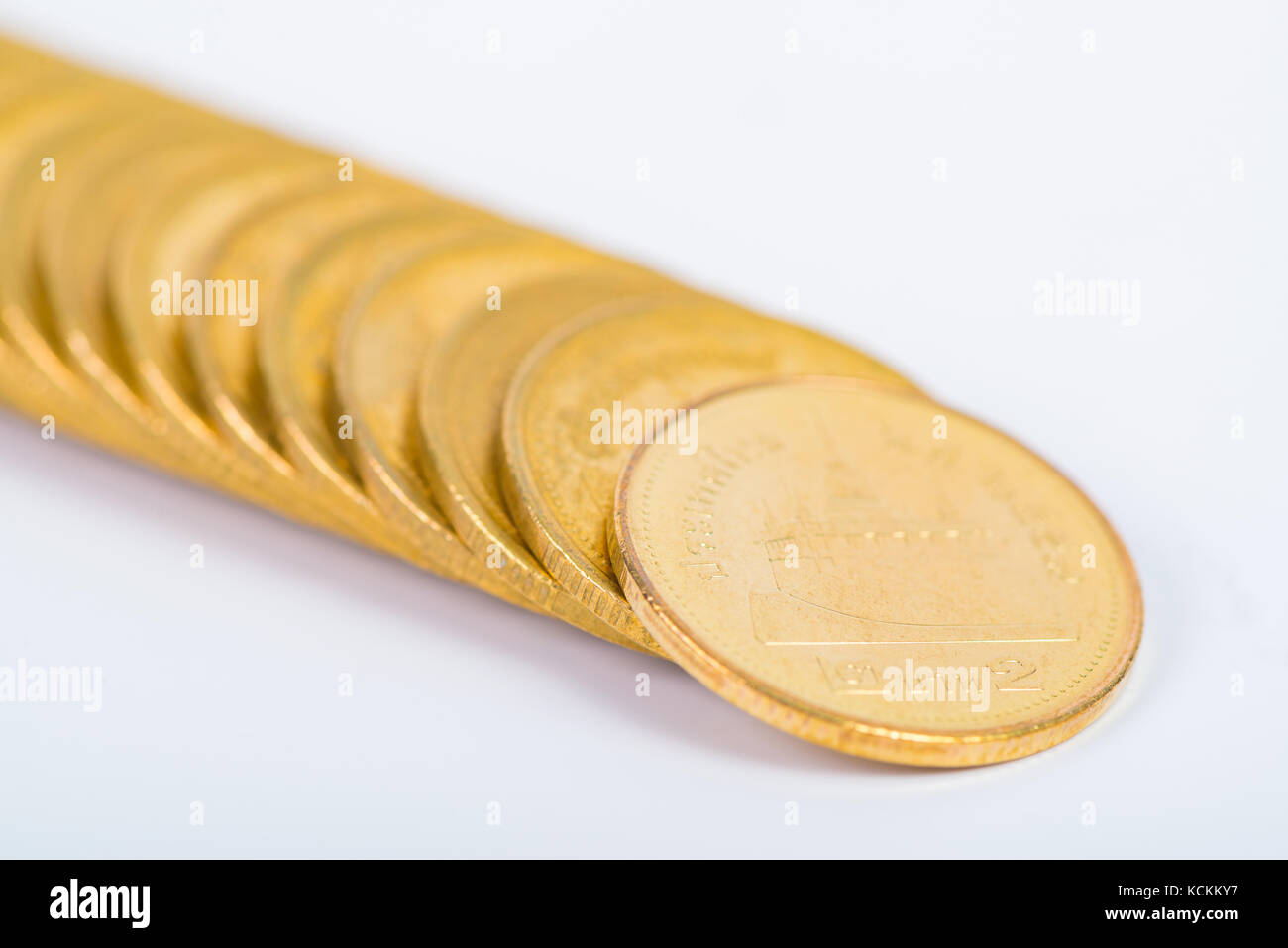 Columns of gold coins, piles of coins arranged on white background ...
