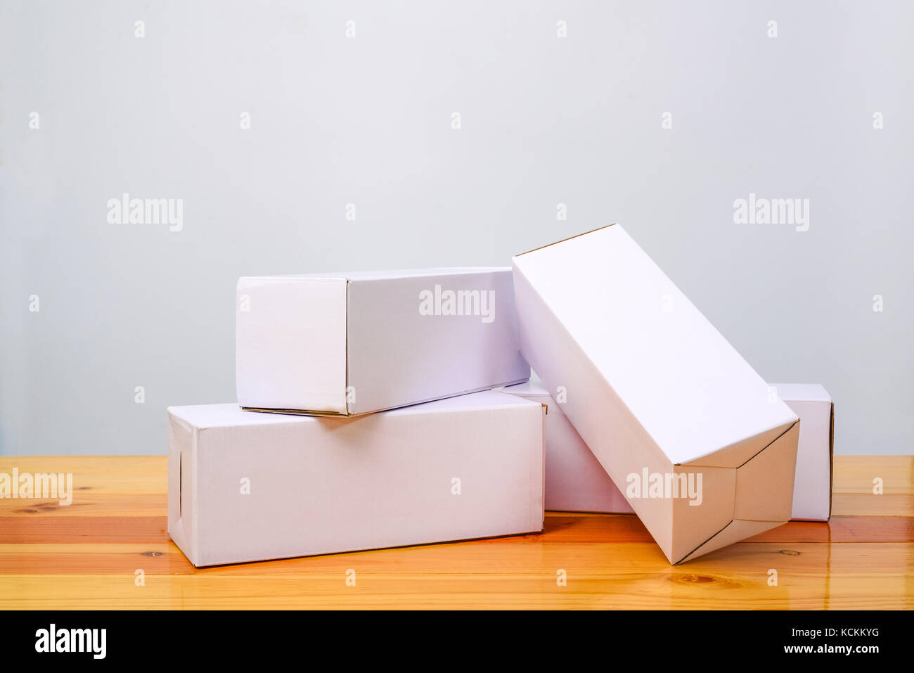 Empty four Package white cardboard box mock up for long items on bright ...