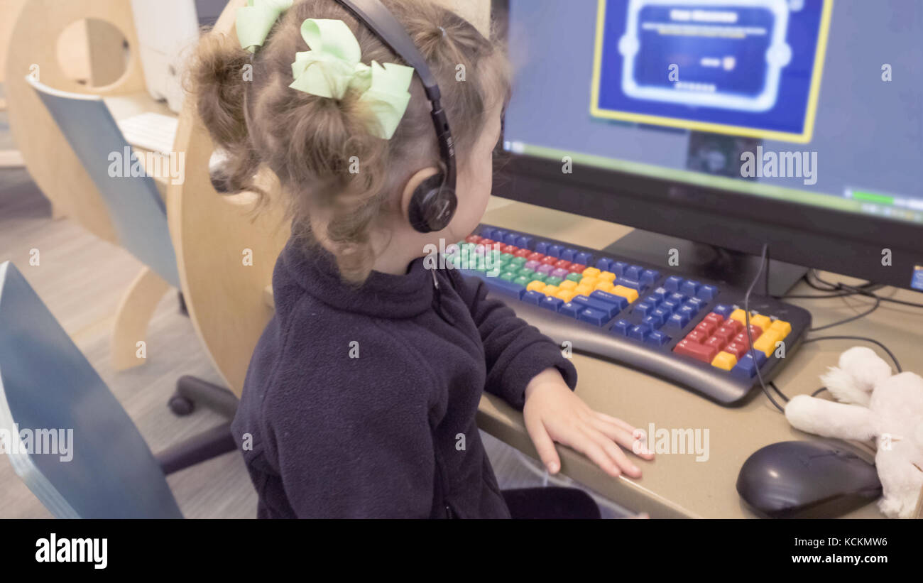 Little girl playing educational games on the computer Stock Photo - Alamy