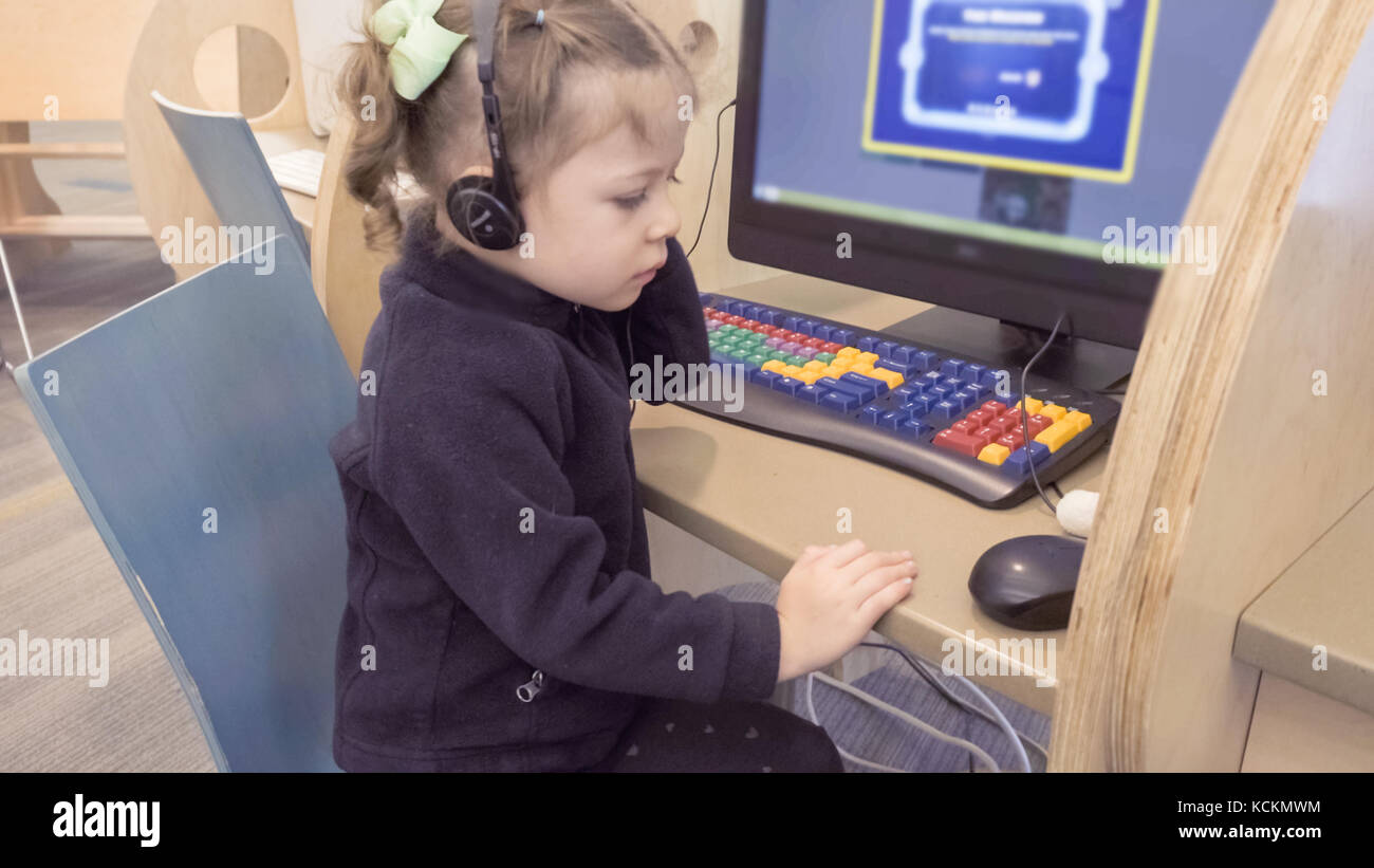 Little girl playing educational games on the computer Stock Photo - Alamy