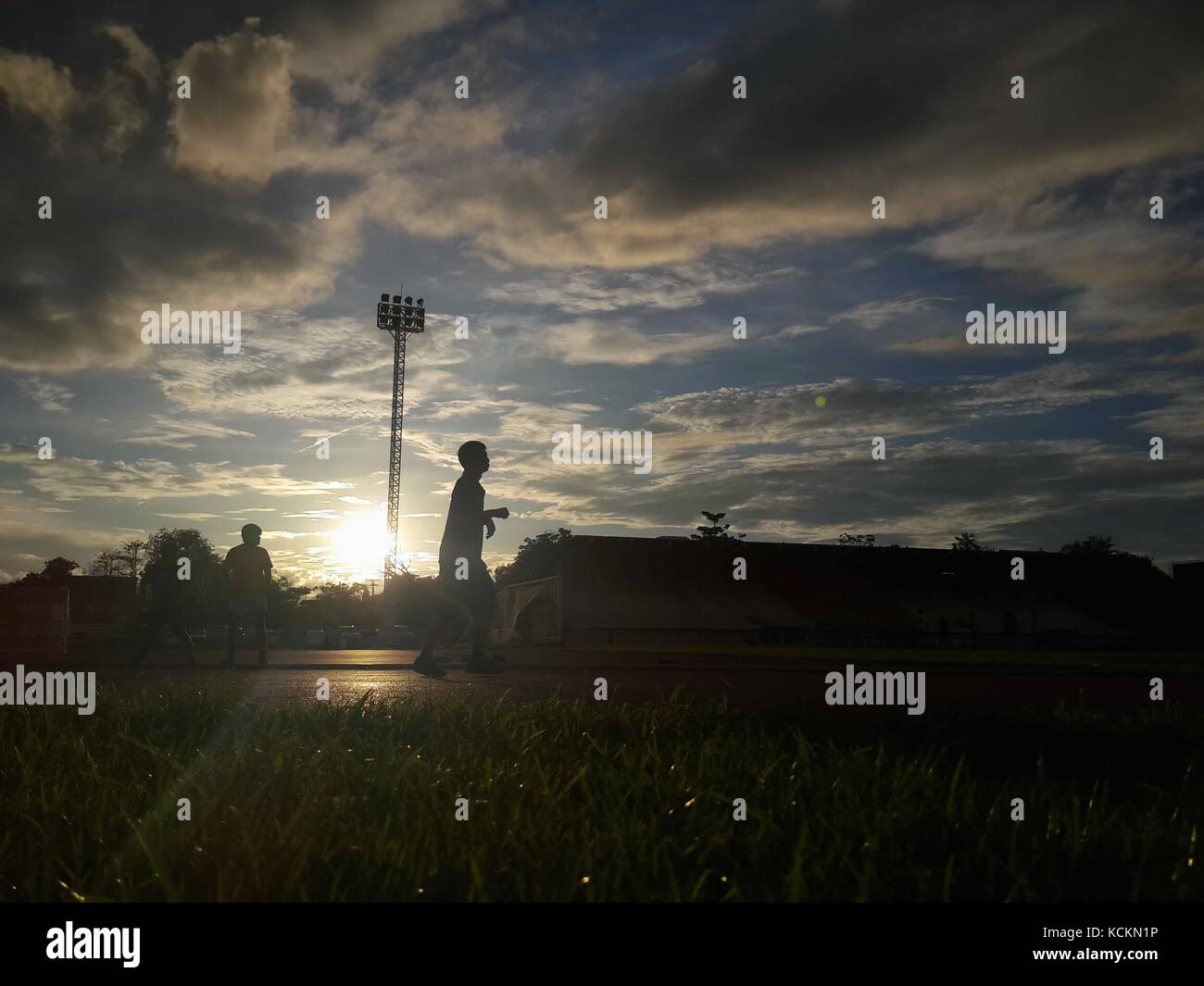 Silhouette running on road at sunrise. Fitness and workout wellness ...