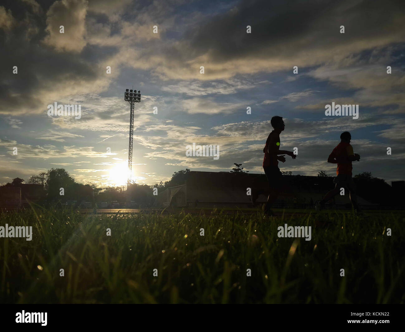 Silhouette running on road at sunrise. Fitness and workout wellness ...