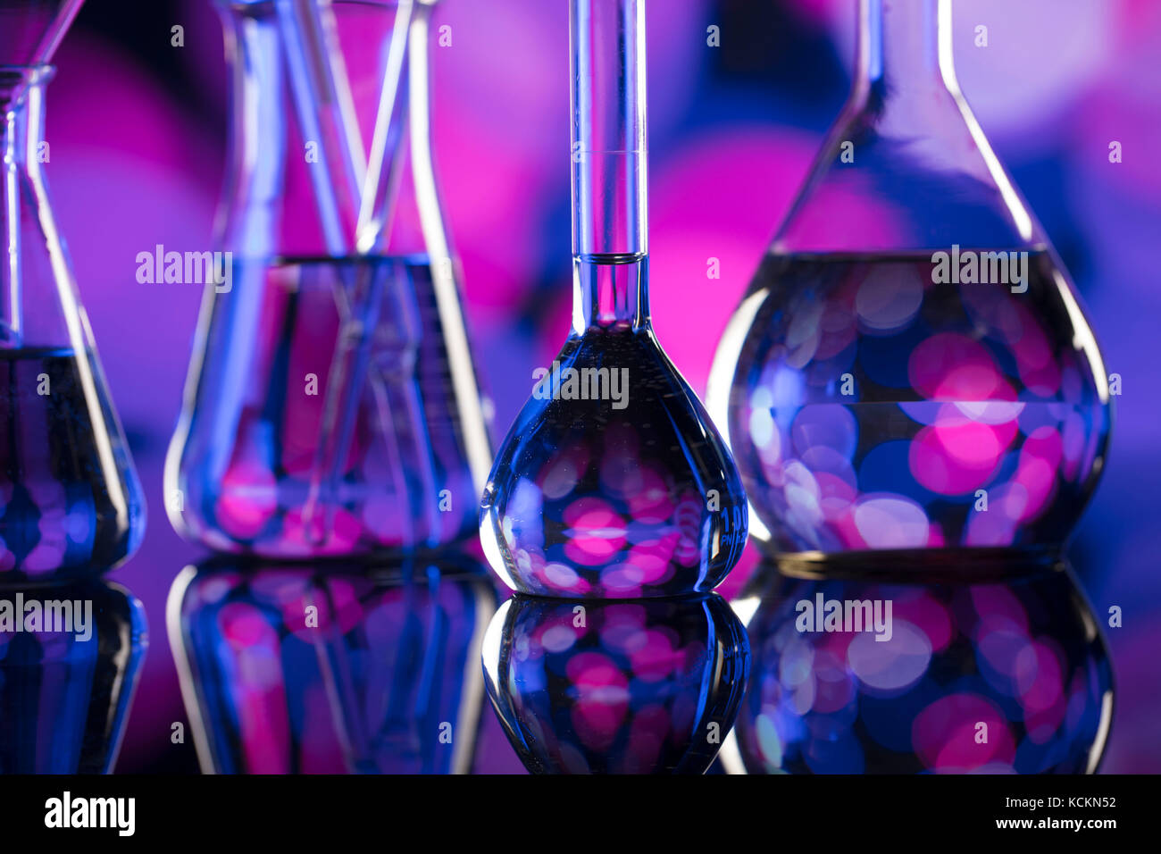 Laboratory concept. Beakers, microscope and test-tubes. Coloful bokeh ...