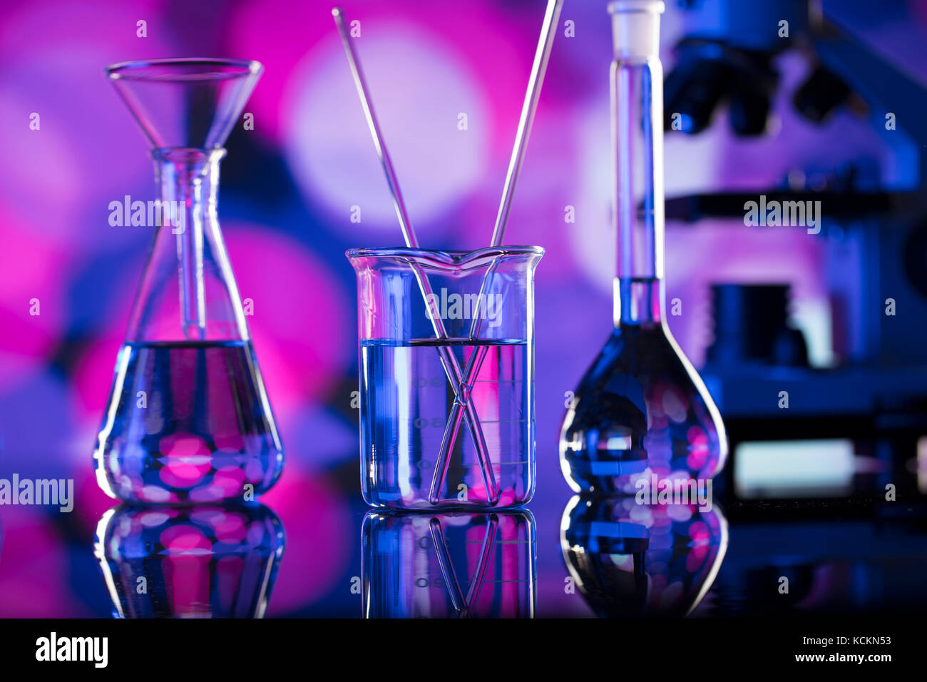 Laboratory concept. Beakers, microscope and test-tubes. Coloful bokeh ...