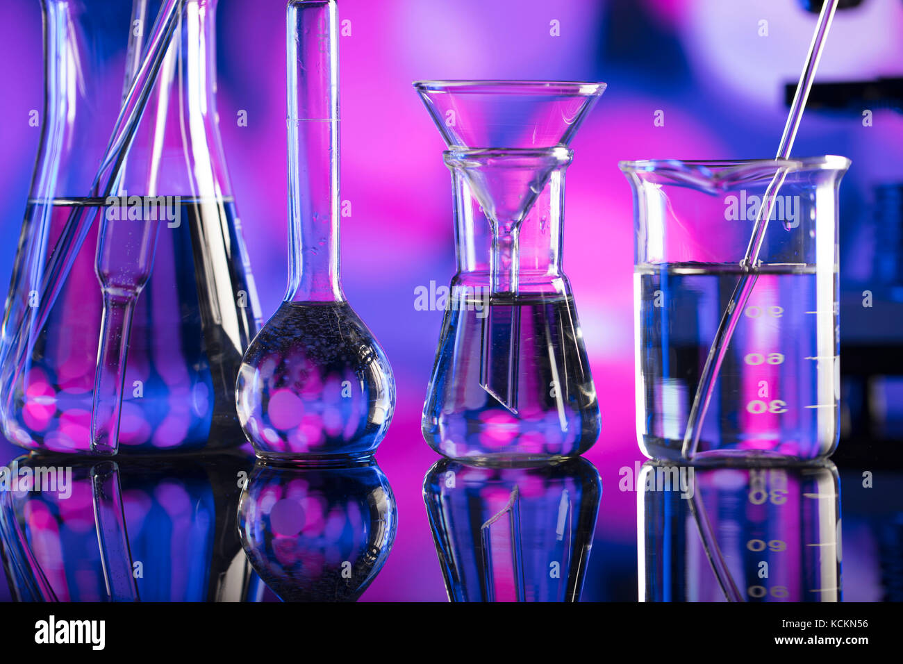 Laboratory concept. Beakers, microscope and test-tubes. Coloful bokeh ...