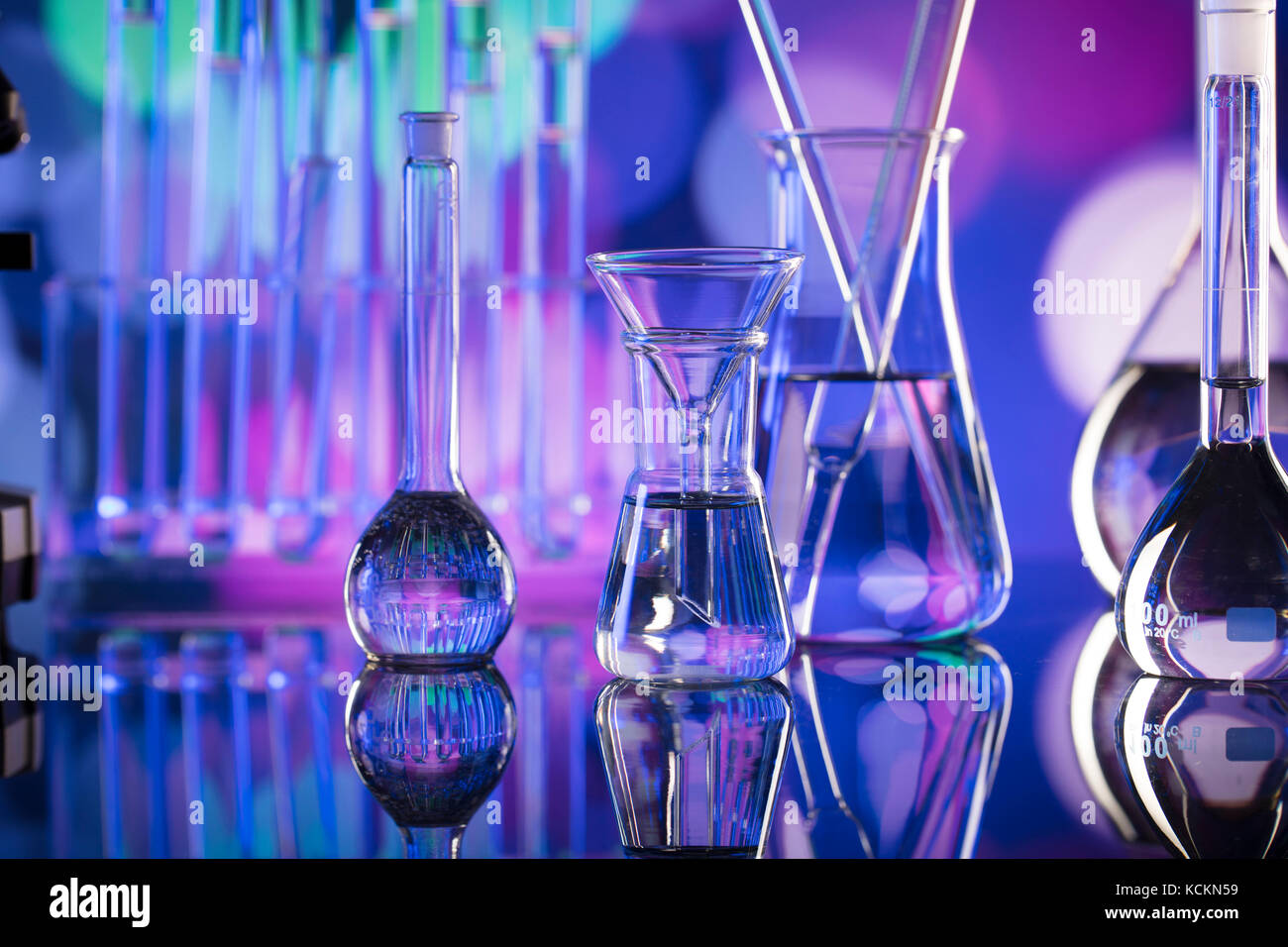 Laboratory concept. Beakers, microscope and test-tubes. Coloful bokeh ...