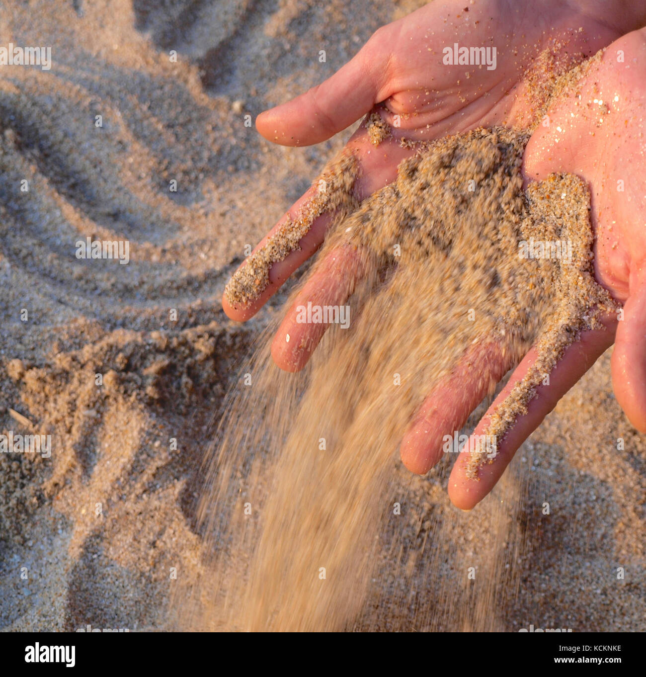 sand falling from hands Stock Photo - Alamy
