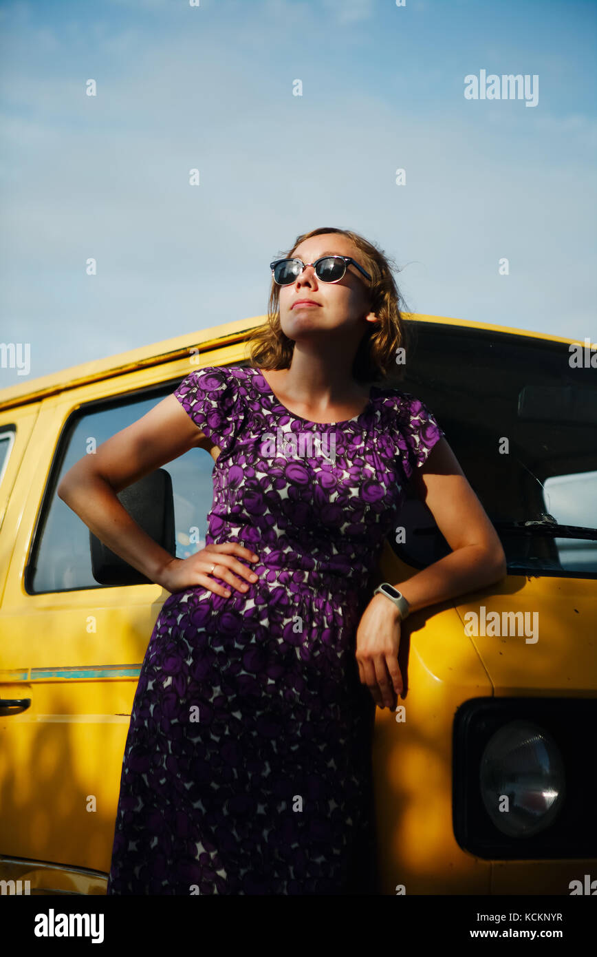 Dreaming girl leaning on van Stock Photo - Alamy