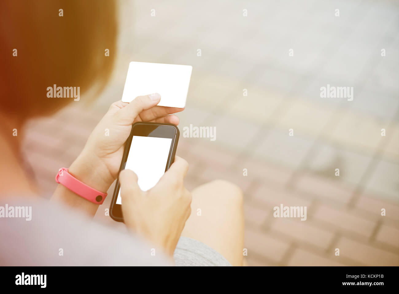 Woman using phone and card for shopping Stock Photo - Alamy