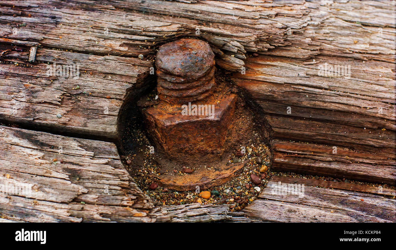 Embedded rusty bolt and nut in a weathered ship plank Stock Photo - Alamy