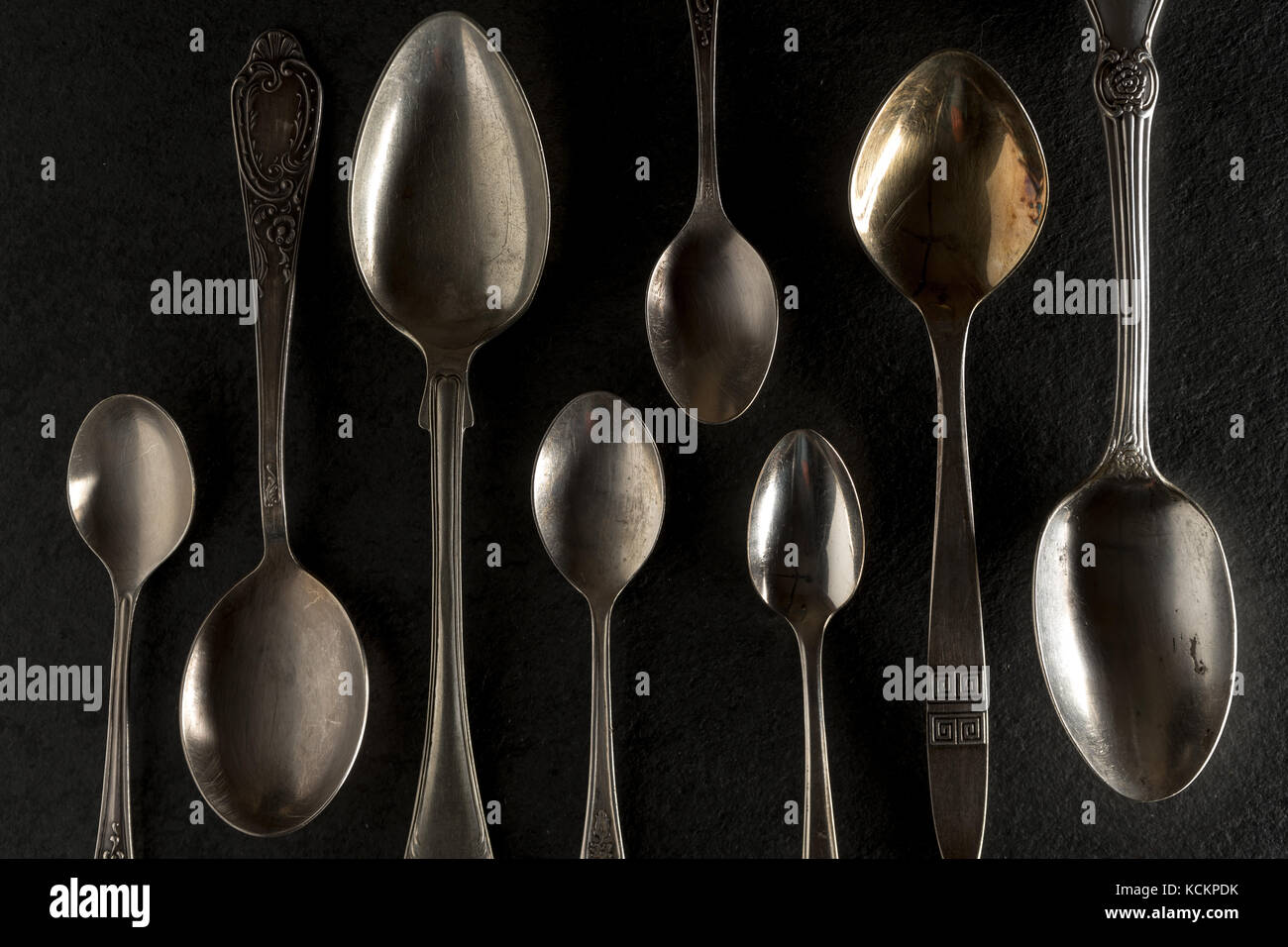 Different spoons on a black stone close-up horizontal Stock Photo - Alamy