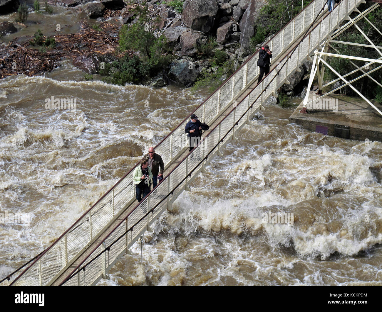 Suspension bridge over South Esk River, in flood. First Basin, Cataract ...