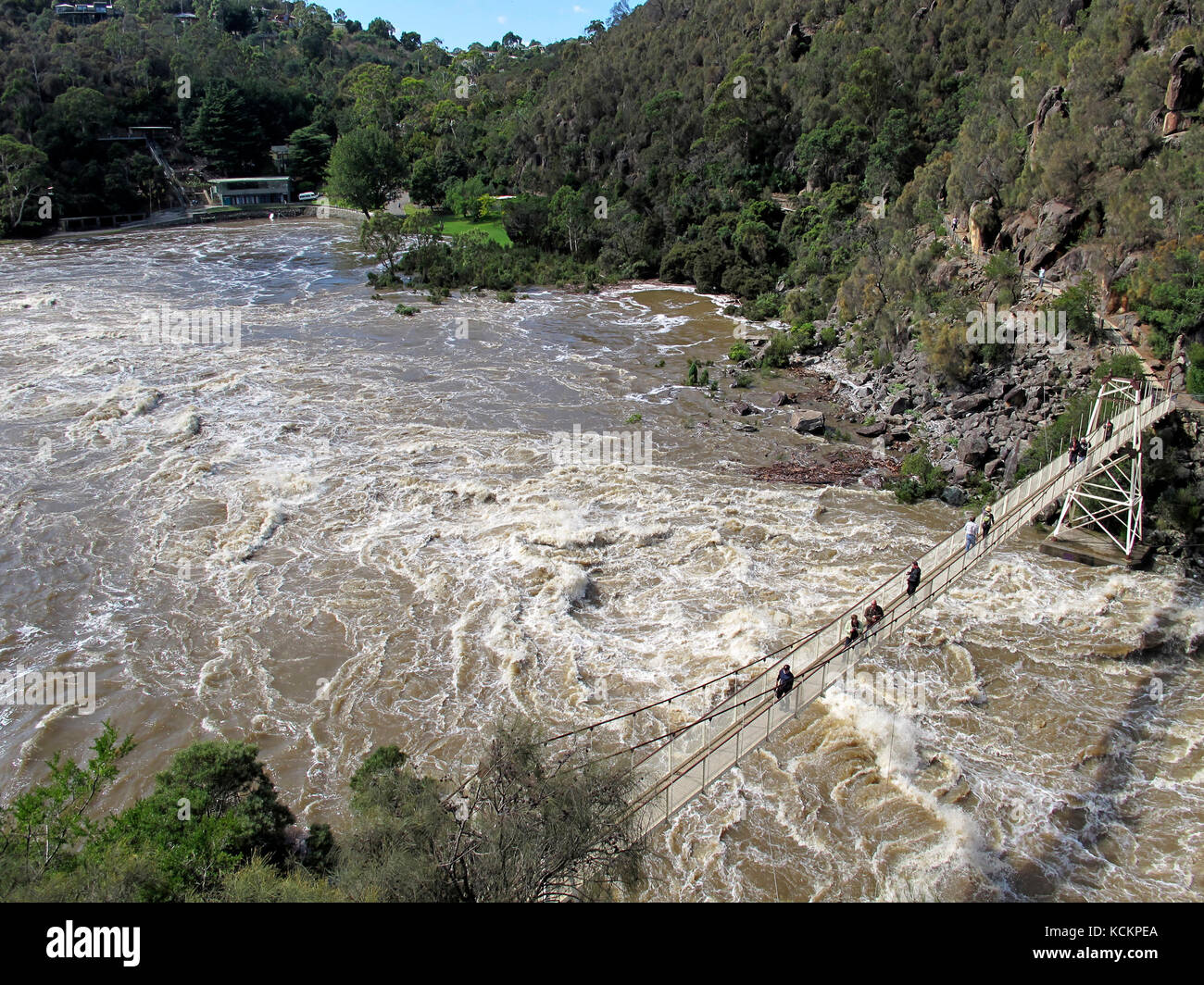 Suspension bridge over South Esk River, in flood. First Basin, Cataract ...