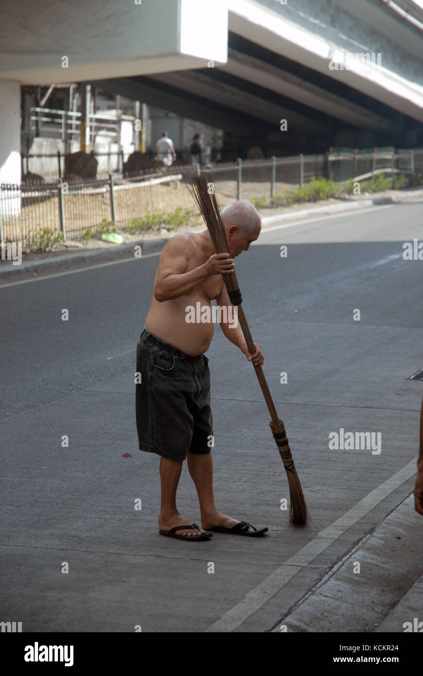 Man sweeps the street early in the morning, Cebu, Philippines Stock ...