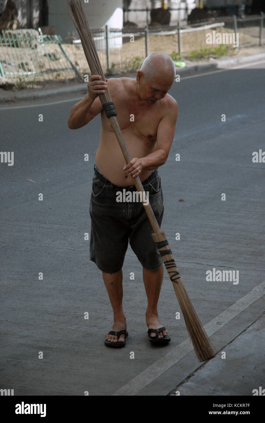 Man sweeps the street early in the morning, Cebu, Philippines Stock ...