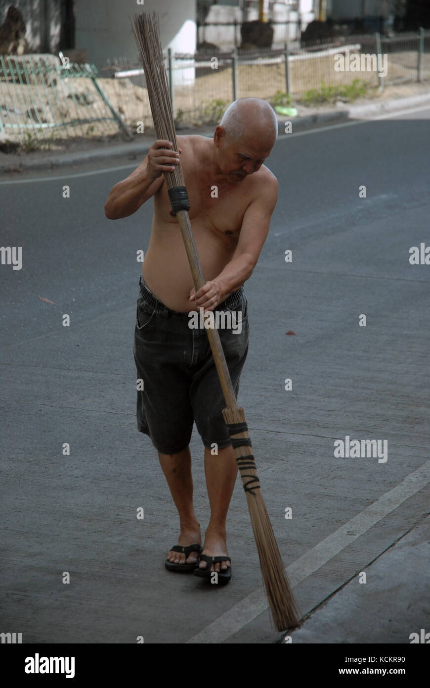 Man sweeps the street early in the morning, Cebu, Philippines Stock ...