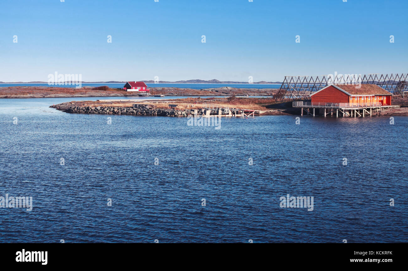 Coastal rural Norwegian landscape, traditional red wooden houses on ...
