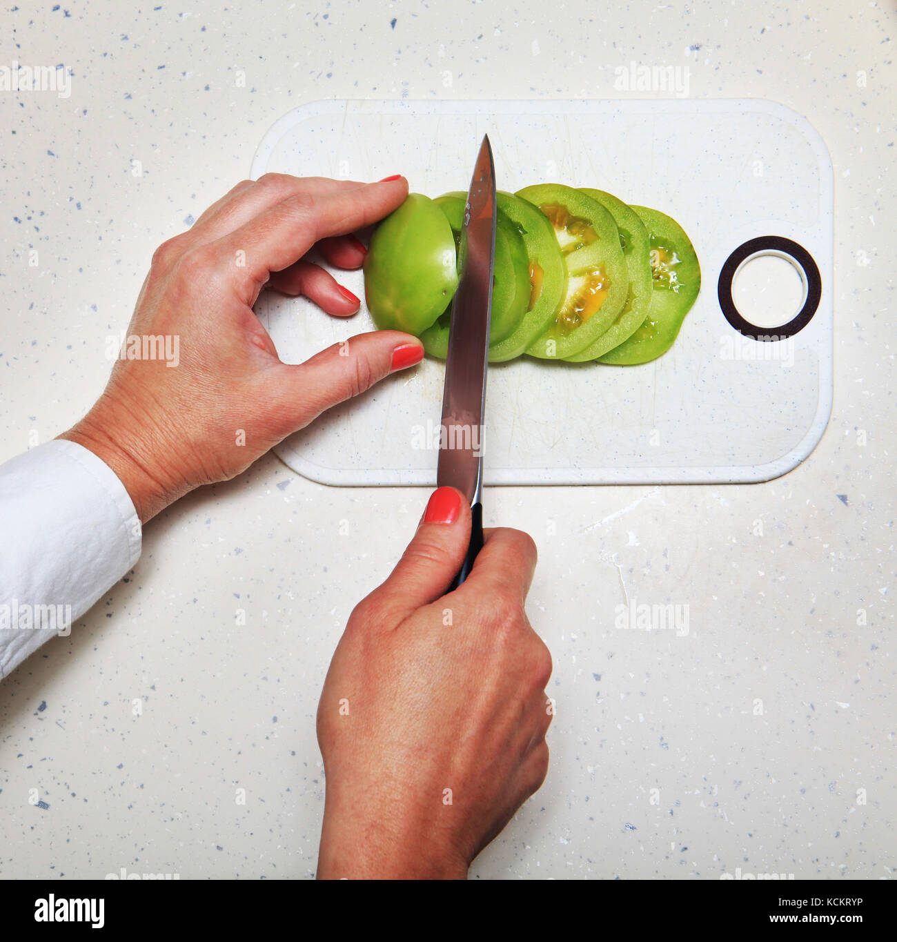 Woman cuts tomato cooking hi-res stock photography and images - Alamy