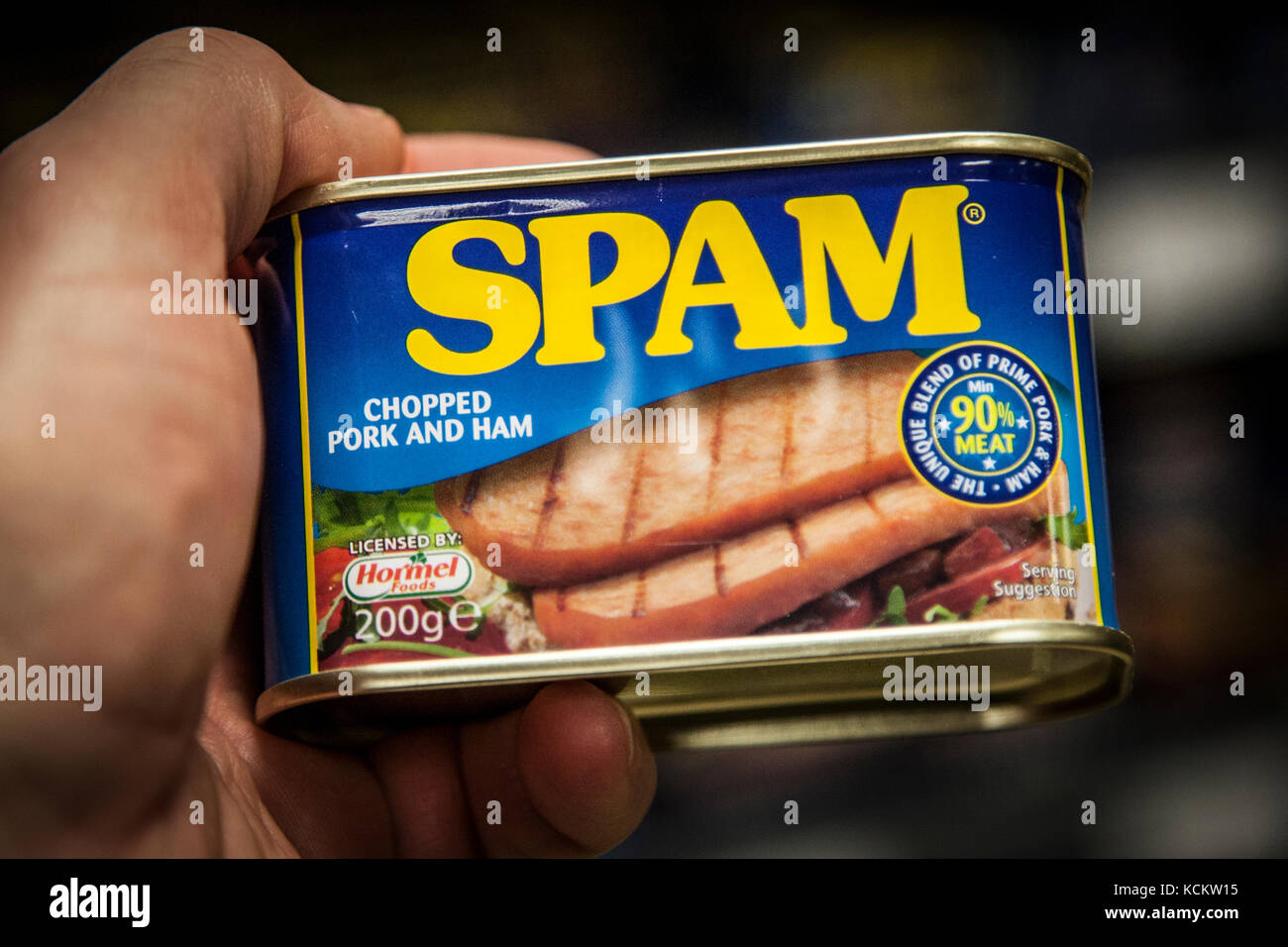 One hand presents a tin can with spam Stock Photo - Alamy