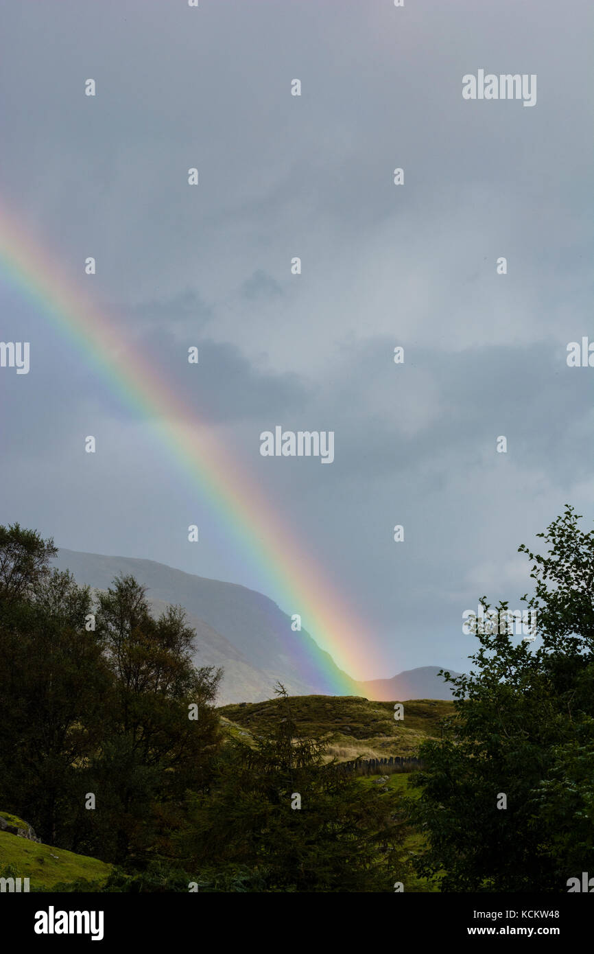rainbow against a stormy sgrey sky Stock Photo - Alamy